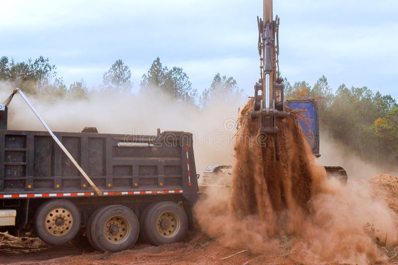 Process of Moving Earth into Dump Truck Using an Excavator on a ...