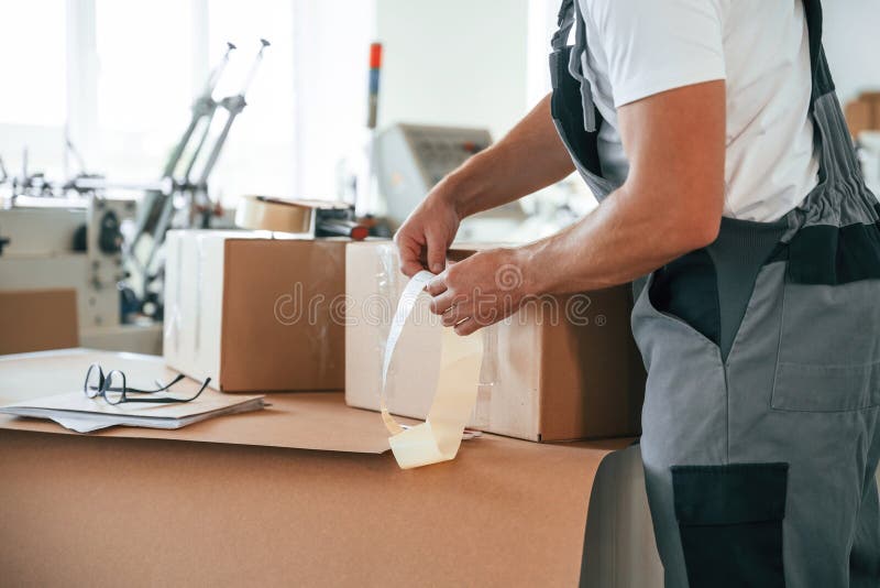Process of Packaging the Product. Handsome Man is Working at the ...