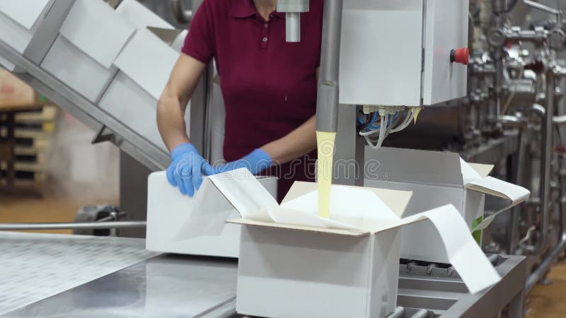 The Process of Packing the Oil or Spread into the Box. the Machine Puts ...