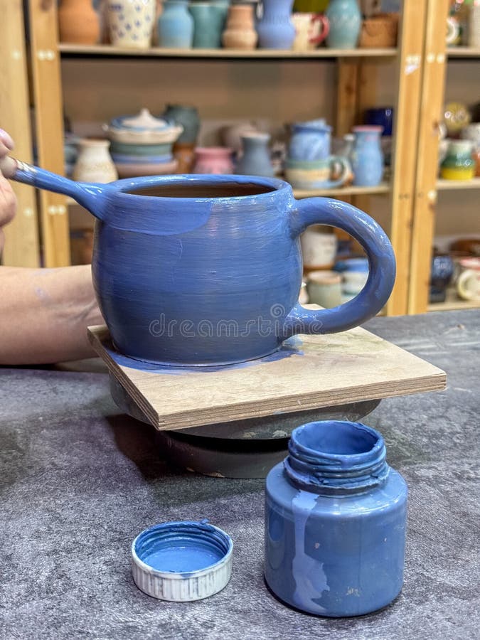 The Process of Painting a Clay Vase during a Ceramics Masterclass ...
