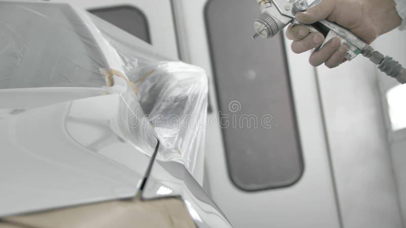 The Process of Painting the Bumper of a White Car in a Spray Booth. Man ...