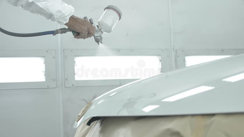Process of Painting a White Car in a Spray Booth. Man Using a Spray Gun ...