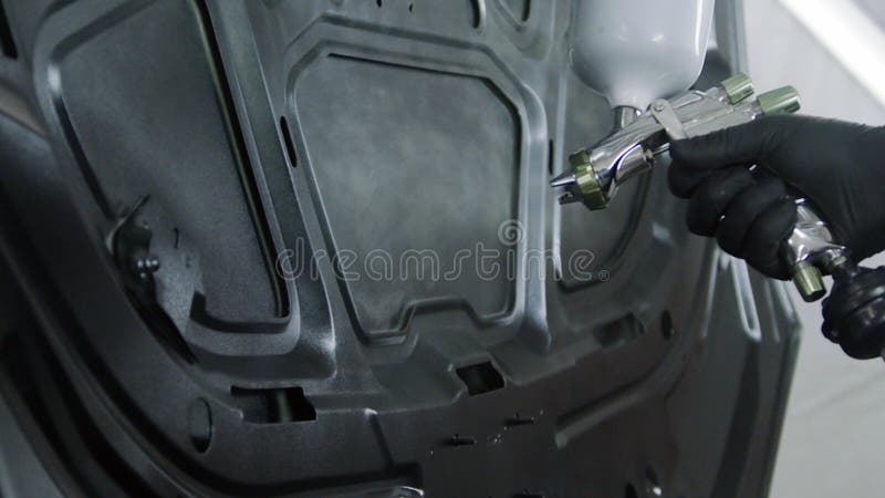 Process of Painting a White Car in a Spray Booth. Man Using a Spray Gun ...