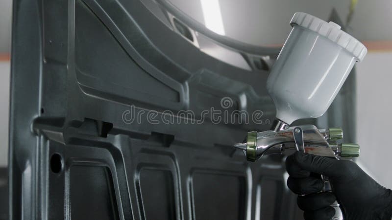 Process of Painting a White Car in a Spray Booth. Man Using a Spray Gun ...