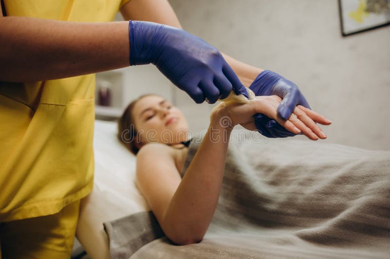 Process Paraffin Treatment of Female Hands in a Beauty Salon. Stock ...