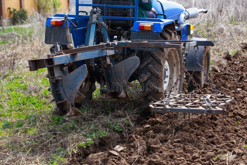 Man Plowing the Land in the Garden on Sky Background Stock Image ...