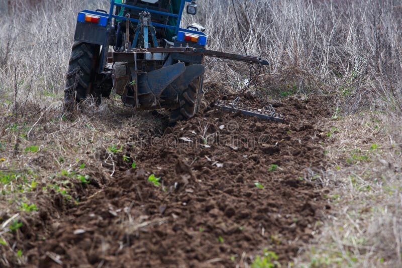 Man Plowing the Land in the Garden on Sky Background Stock Image ...