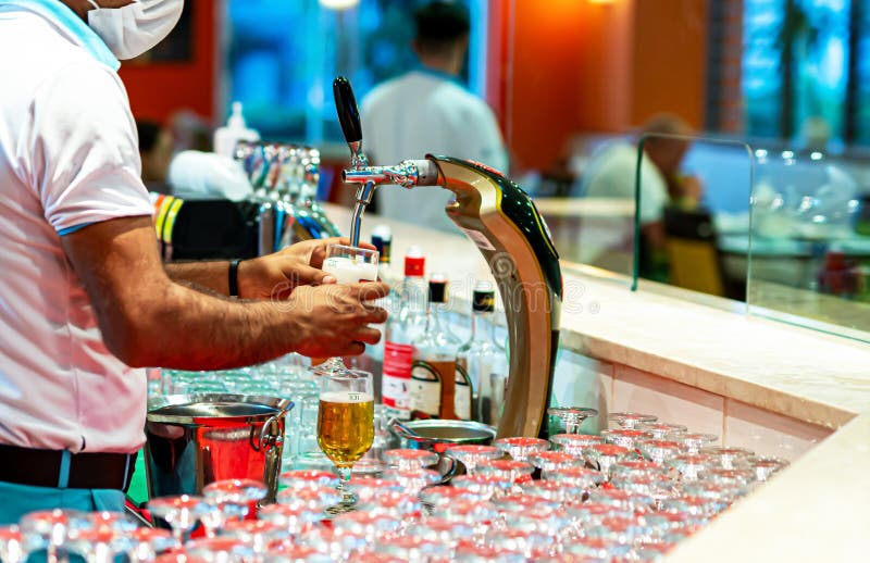The Process of Pouring Beer into a Glass in a Bar Stock Image - Image ...