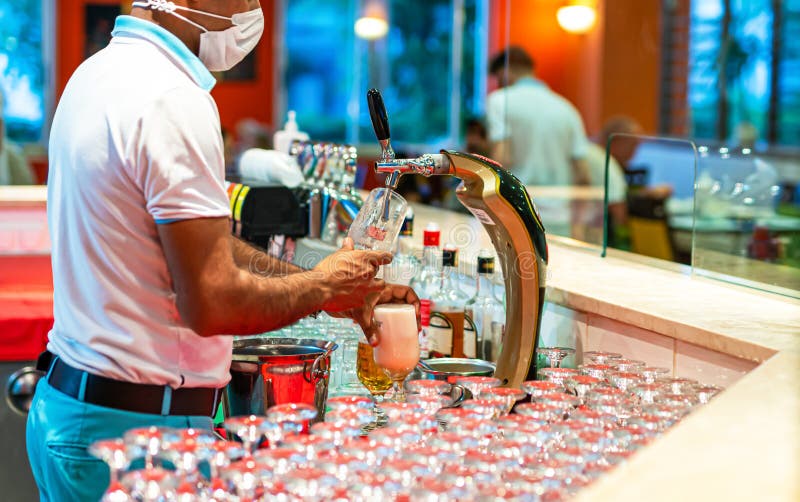 The Process of Pouring Beer into a Glass in a Bar Stock Photo - Image ...