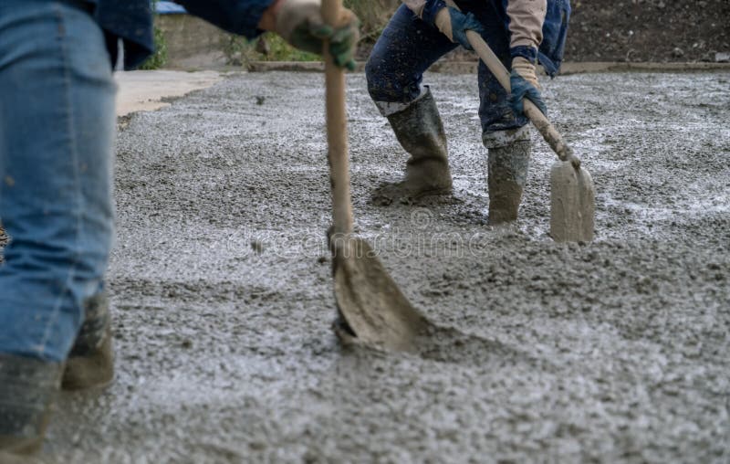 The Process of Pouring Concrete on a Prepared Base Made of Sand Stock ...