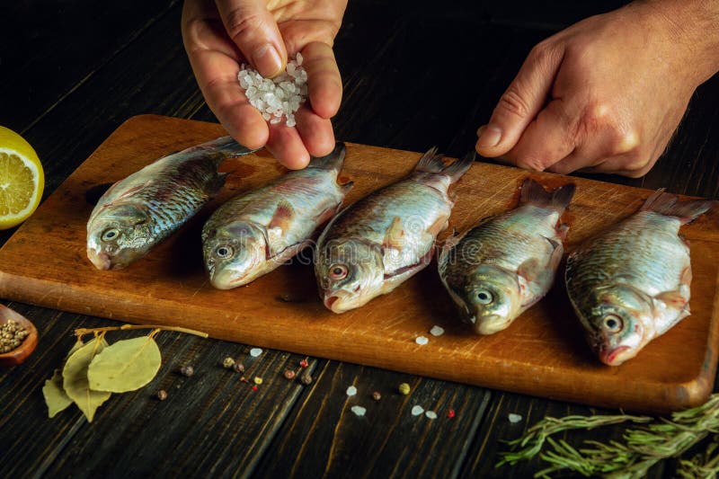The Process of Preparing Crucian Fish on the Kitchen Table. Chef Hands ...