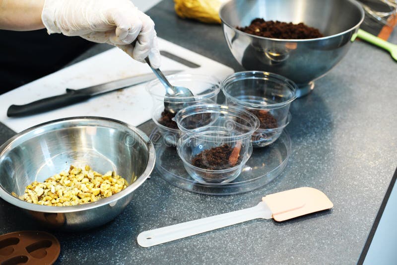 The Process of Preparing a Multi-layered Dessert.the Confectioner Puts ...