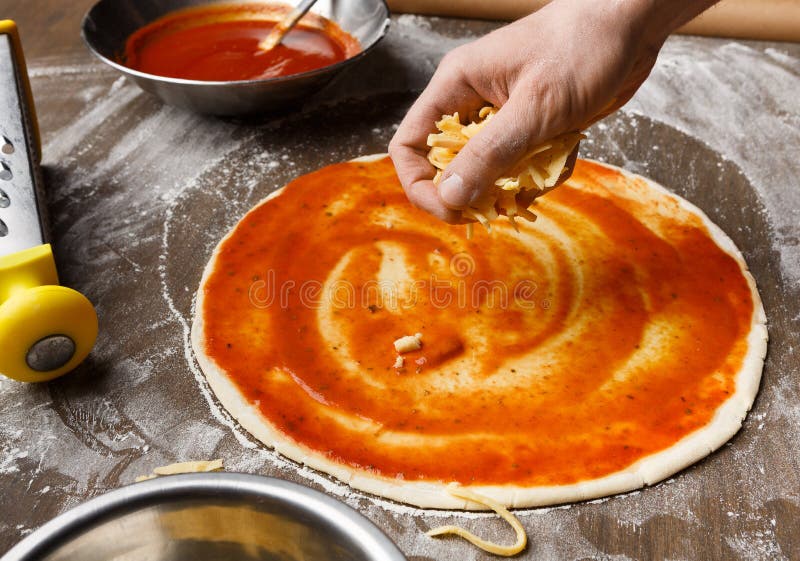 Process of Preparing Pizza. Man Adding Cheese on Base Stock Image ...