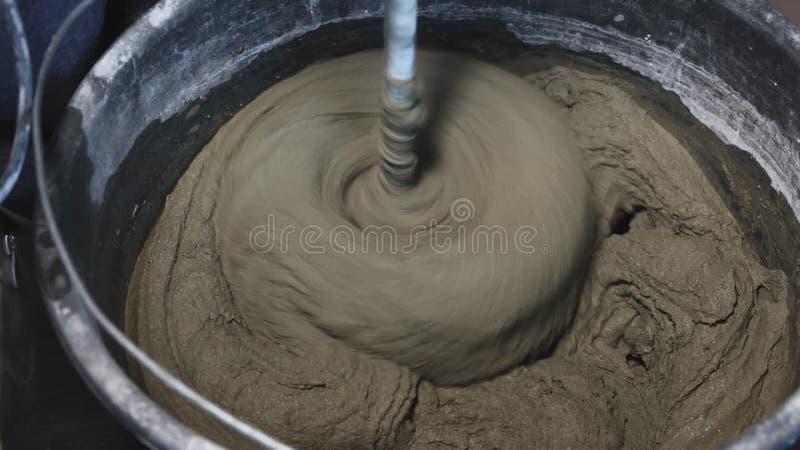 The Process of Preparing Tile Adhesive or Cement Mortar. Mechanical ...