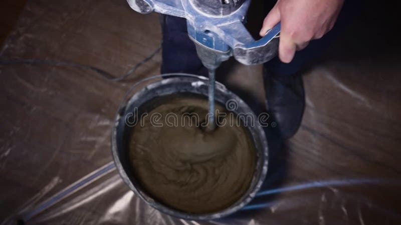 The Process of Preparing Tile Adhesive or Cement Mortar. Mechanical ...