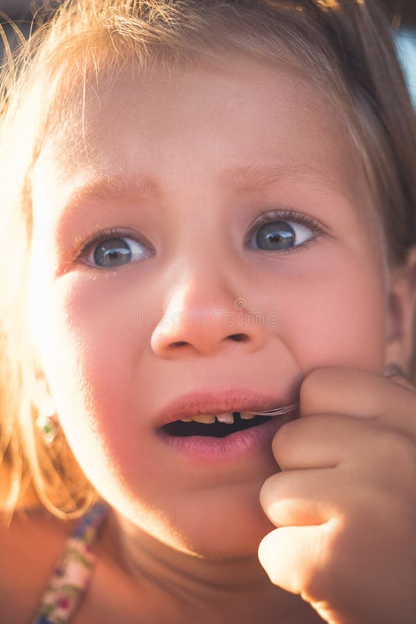 The Process of Removing a Baby Tooth Using a Thread Stock Photo - Image ...