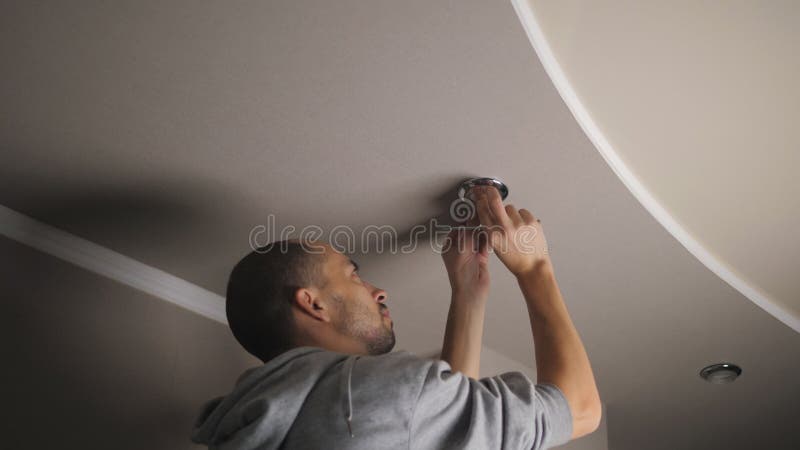 A Man Repairs a Ceiling LED Light in the House. Stock Footage - Video ...
