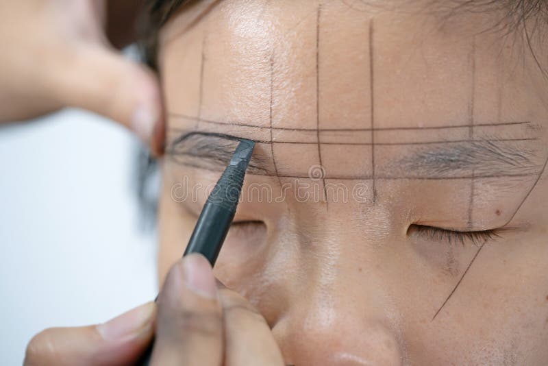 The Process of Shaping Eyebrows by a Beauty Master with a Thread for a ...