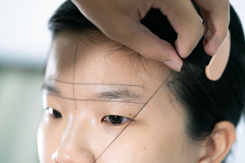 The Process of Shaping Eyebrows by a Beauty Master with a Thread for a ...