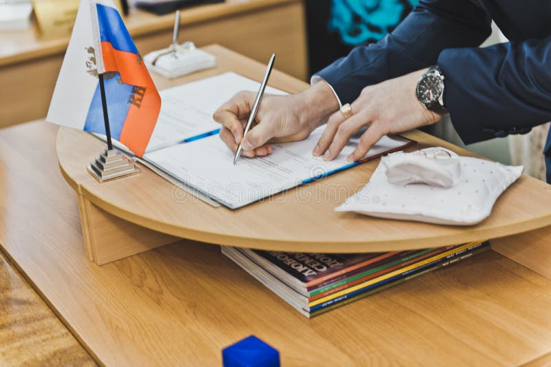 The Process of Signing the Document on the Table. Stock Image - Image ...