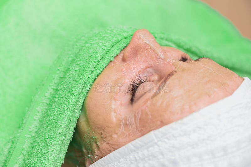 Application of an Enzyme Mask with a Brush on a Woman`s Face Top View ...
