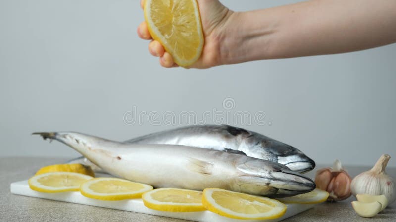 The Process of Squeezing Lemon Juice from Half a Lemon Onto Uncooked ...