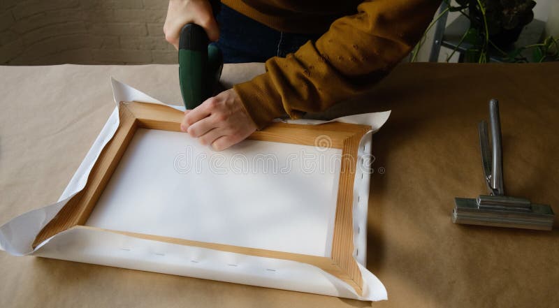Artist& X27;s Hands Stretching Canvas on Stretcher Bars Using Staple ...