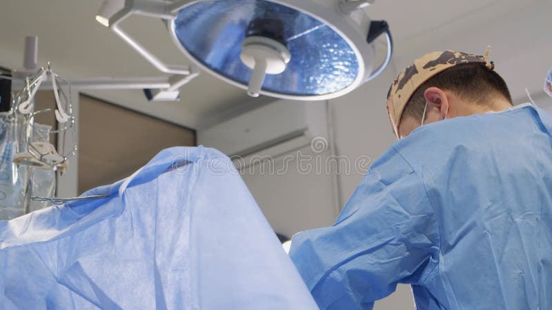 The Process of the Surgeon S Work in the Operating Room, he Performs an ...