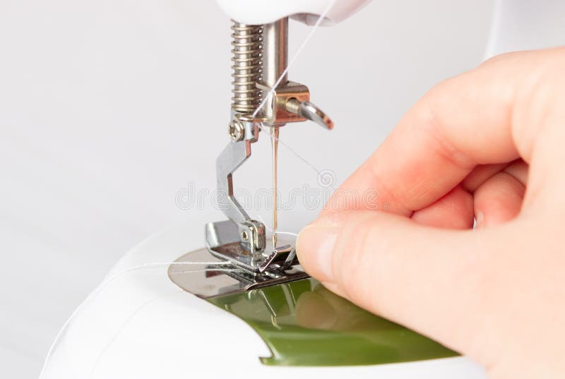 The Process of Threading the Thread into the Needle Eye of a Sewing ...