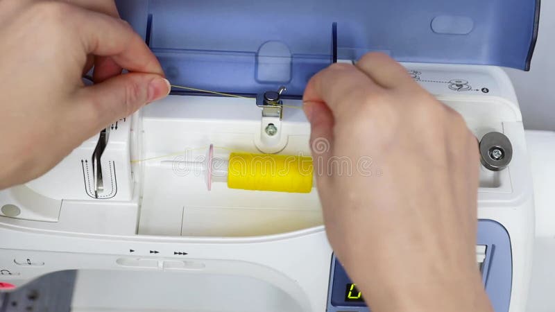 The Process of Winding White Thread on the Bobbin of a Modern Sewing ...