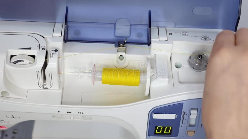 The Process of Winding White Thread on the Bobbin of a Modern Sewing ...