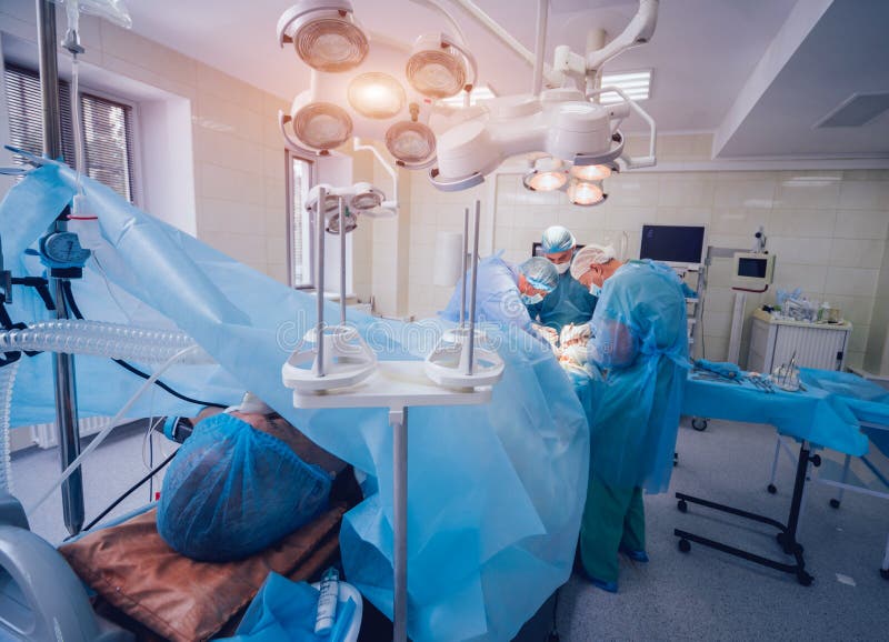 Process Of Trauma Surgery Operation. Group Of Surgeons In Operating ...