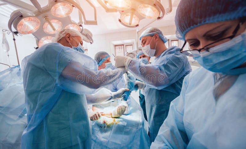 Process Of Trauma Surgery Operation. Group Of Surgeons In Operating ...