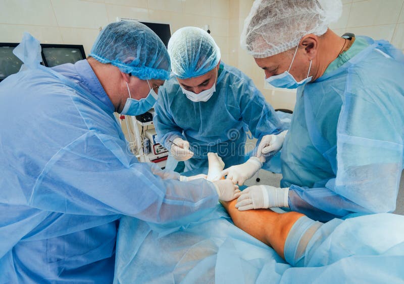 Process of Trauma Surgery Operation. Group of Surgeons in Operating ...