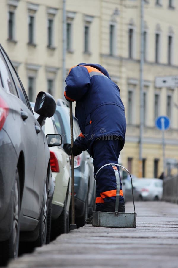 Process of Urban Street Cleaning Sweeping. Worker with Broom and Dust ...