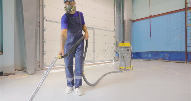The Process of Vacuuming a Polymer Floor after Finishing Work. Cleaning ...