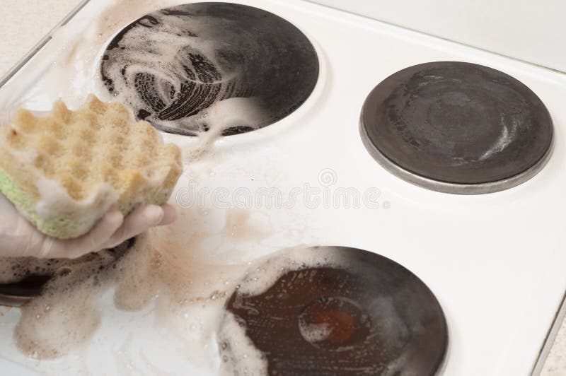 The Process of Washing the Stove with a Sponge and Rubber Gloves Stock ...