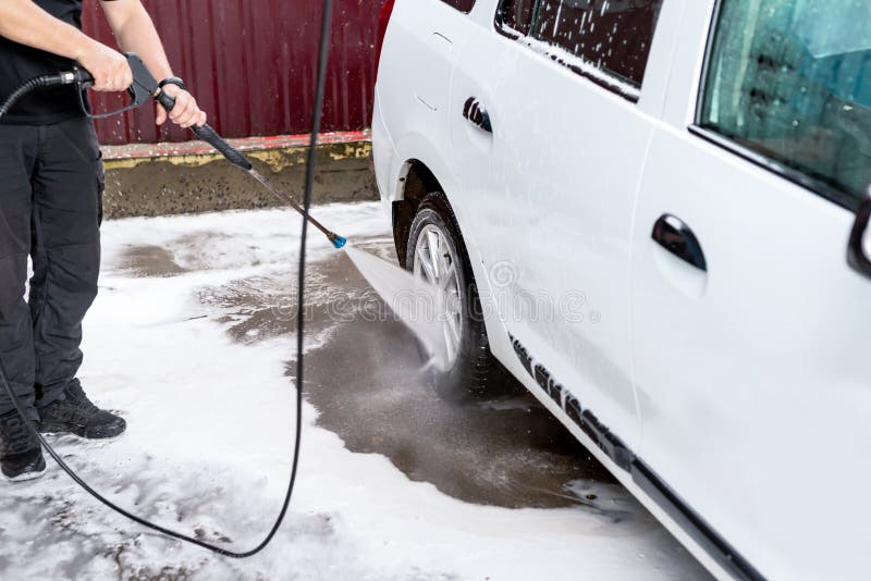 The Process of Washing a White Car Using a Pressure Washer Stock Photo ...