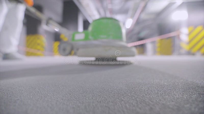 Processing a Concrete Floor with a Grinder Close-up. Grinding Concrete ...