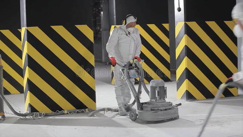 Floor Grinding at a Construction Site. a Builder Works with an ...