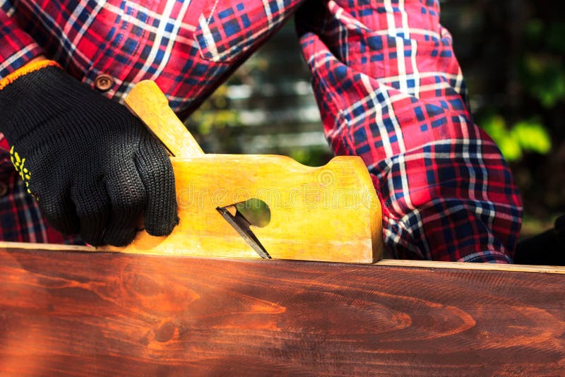 Processing the End of the Board with a Plane. Carpentry Workshop. Hobby ...