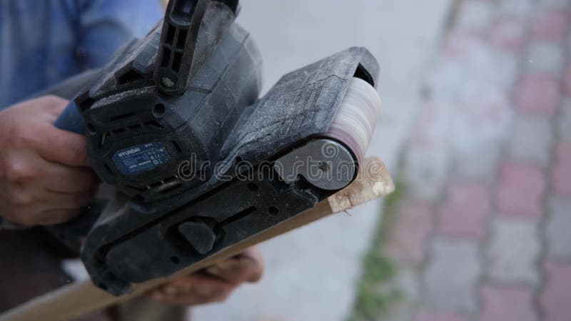 The Man S Hands are Holding a Grinding Machine. Processing of a ...