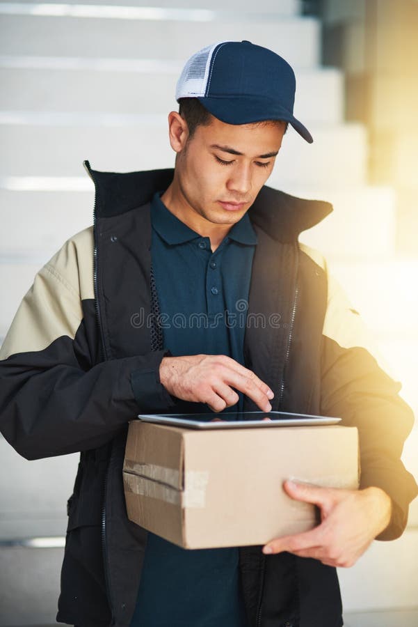 Processing His Deliveries the Digital Way. a Courier Using a Digital ...