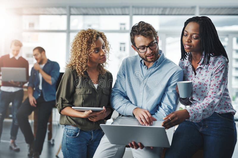 Producing Results is What they Do. a Group of Colleagues Using a Laptop ...