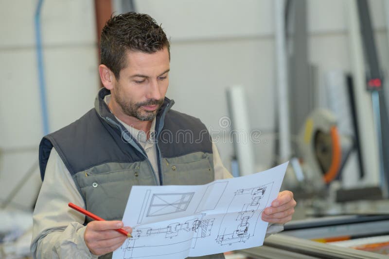 Engineer Studying Component in Workshop Stock Photo - Image of ...