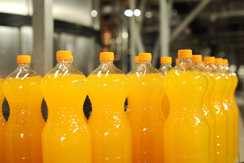 Production of Carbonated Drinks. Orange Bottles on the Production Line ...