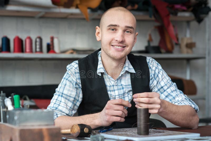 Leather Products, the Master Smiles in the Process of Hand Sewing the ...