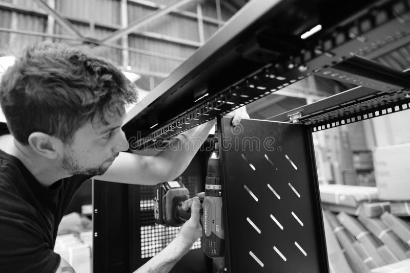 Production Line Worker Seen Assembling Data Cabinets at a Factory ...