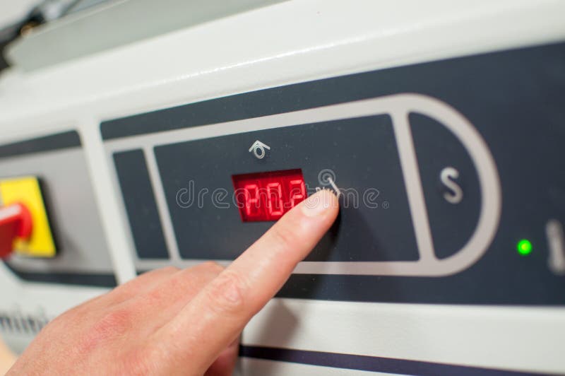 A Worker`s Hand Pushes a Button on the Control Panel of a Production ...