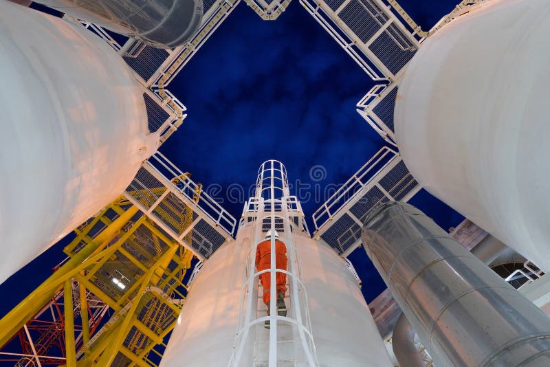 Production Operator Stepping Up To Gas Dehydration Vessel To Inspect ...